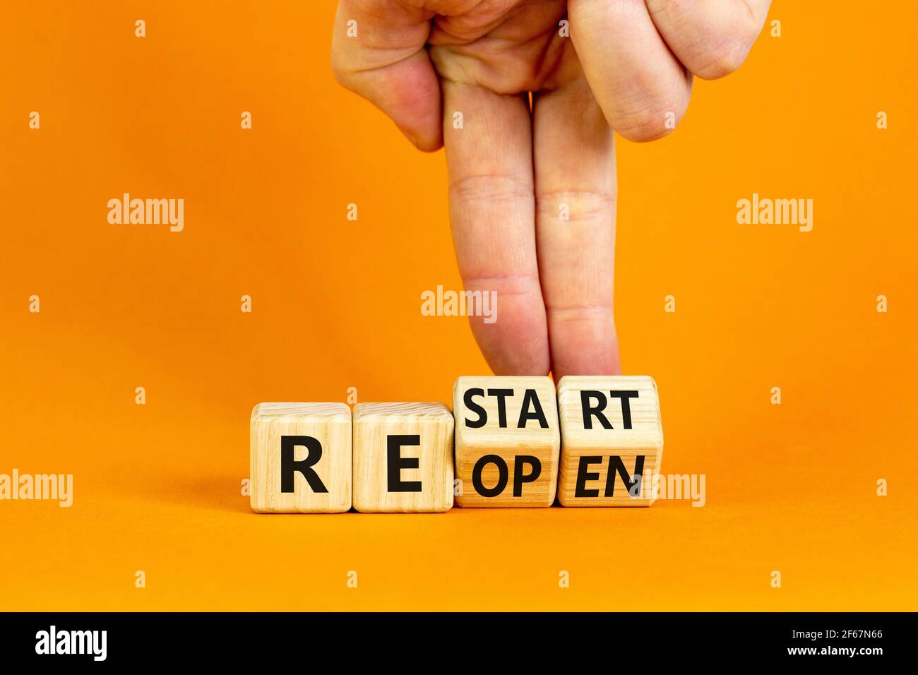 Reopen and restart symbol. Businessman hand turns cubes and changes the ...