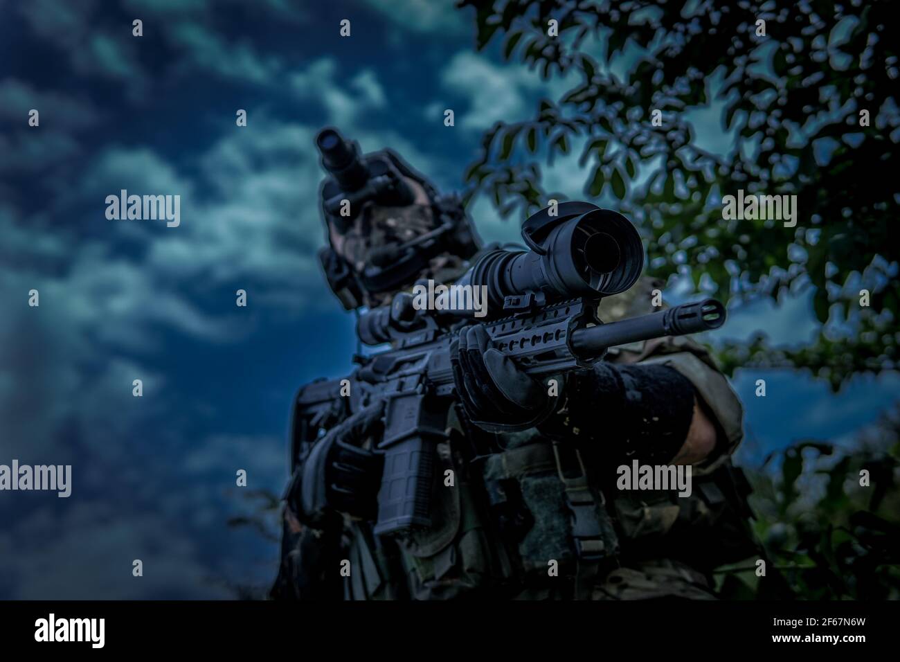 The soldier is holding a weapon with a telescopic sight. View from the ...