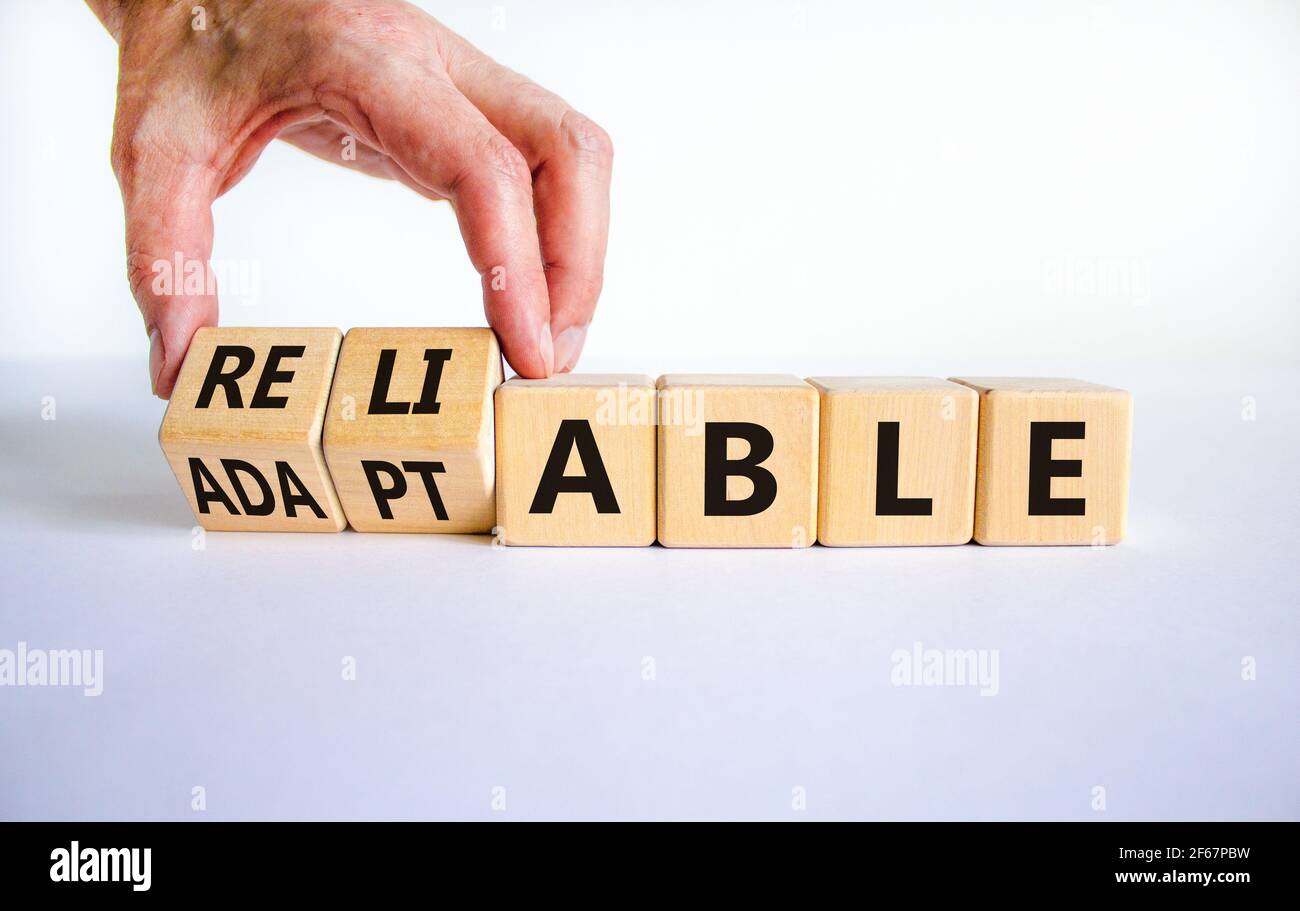 Adaptable or reliable symbol. Businessman turns wooden cubes and ...