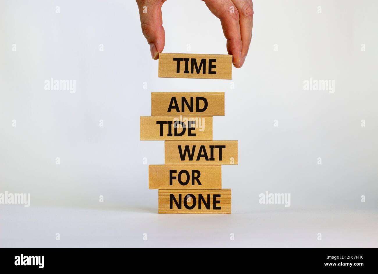 Time to action symbol. Wooden blocks with words time and tide wait for ...