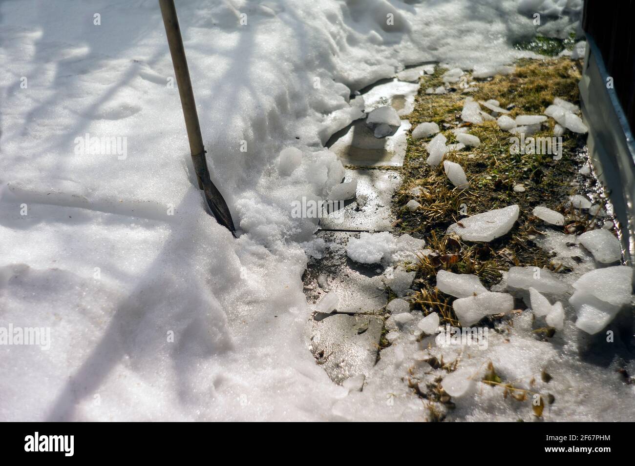 Removing ice from a footpath, springtime outdoor shot Stock Photo - Alamy