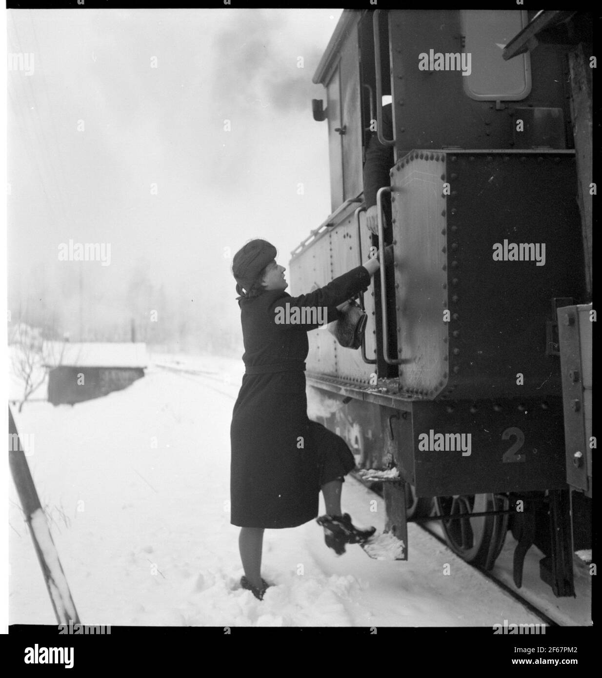 Woman at a steam locomotive Stock Photo - Alamy