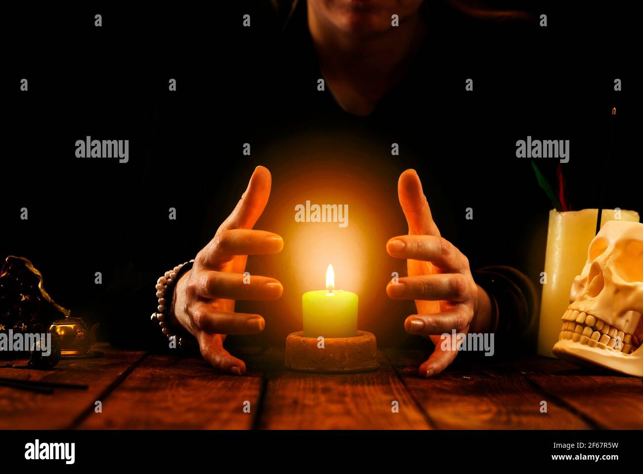 A fortune-teller or oracle with objects for fortune-telling holds a ...