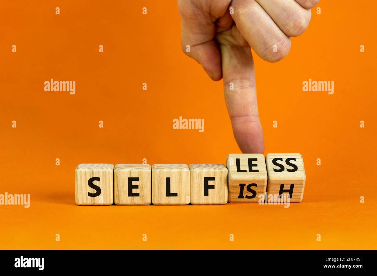 Selfish or selfless symbol. Businessman turns cubes and changes the ...