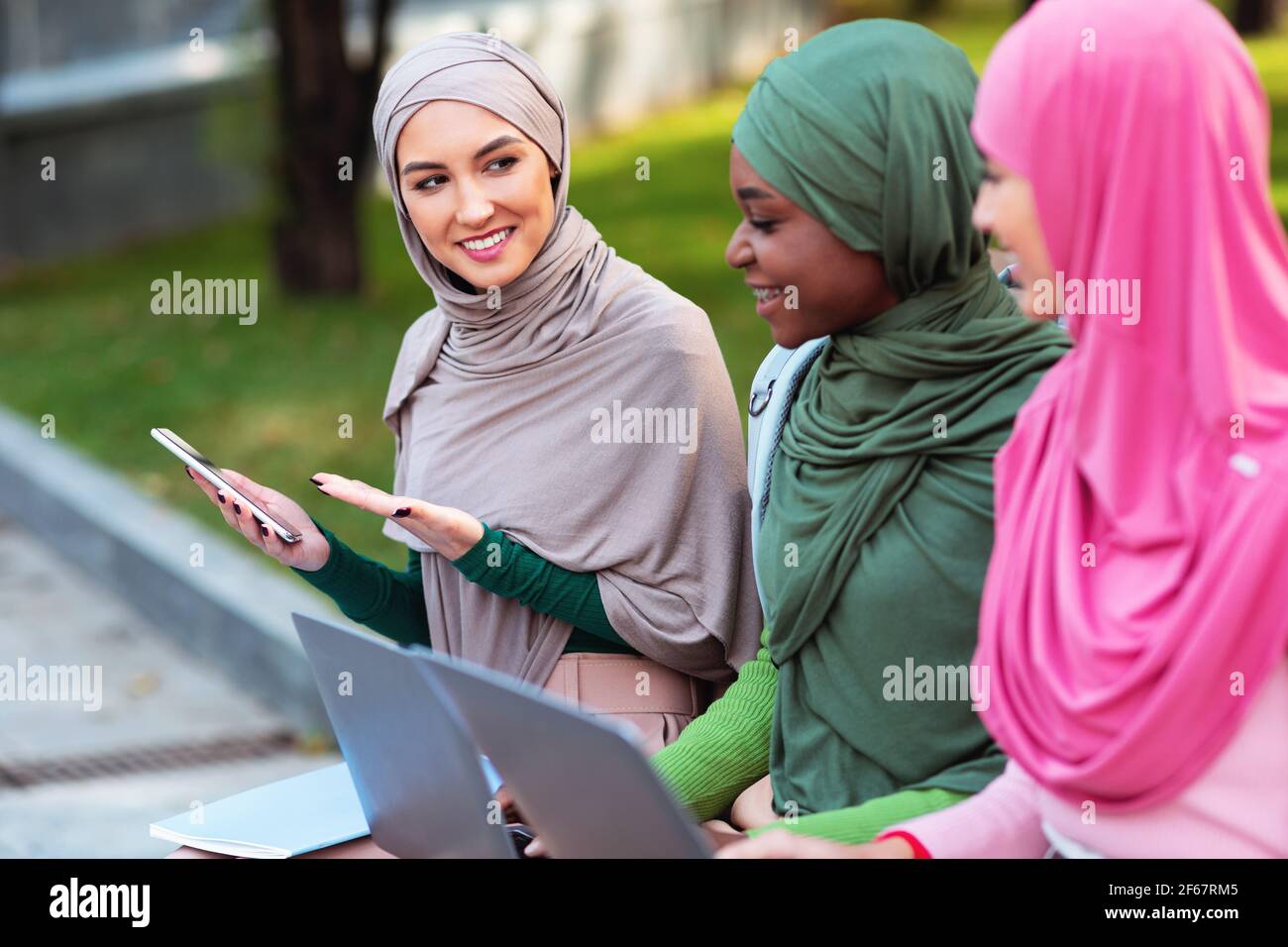 Student phone laptop group muslim hi-res stock photography and images ...