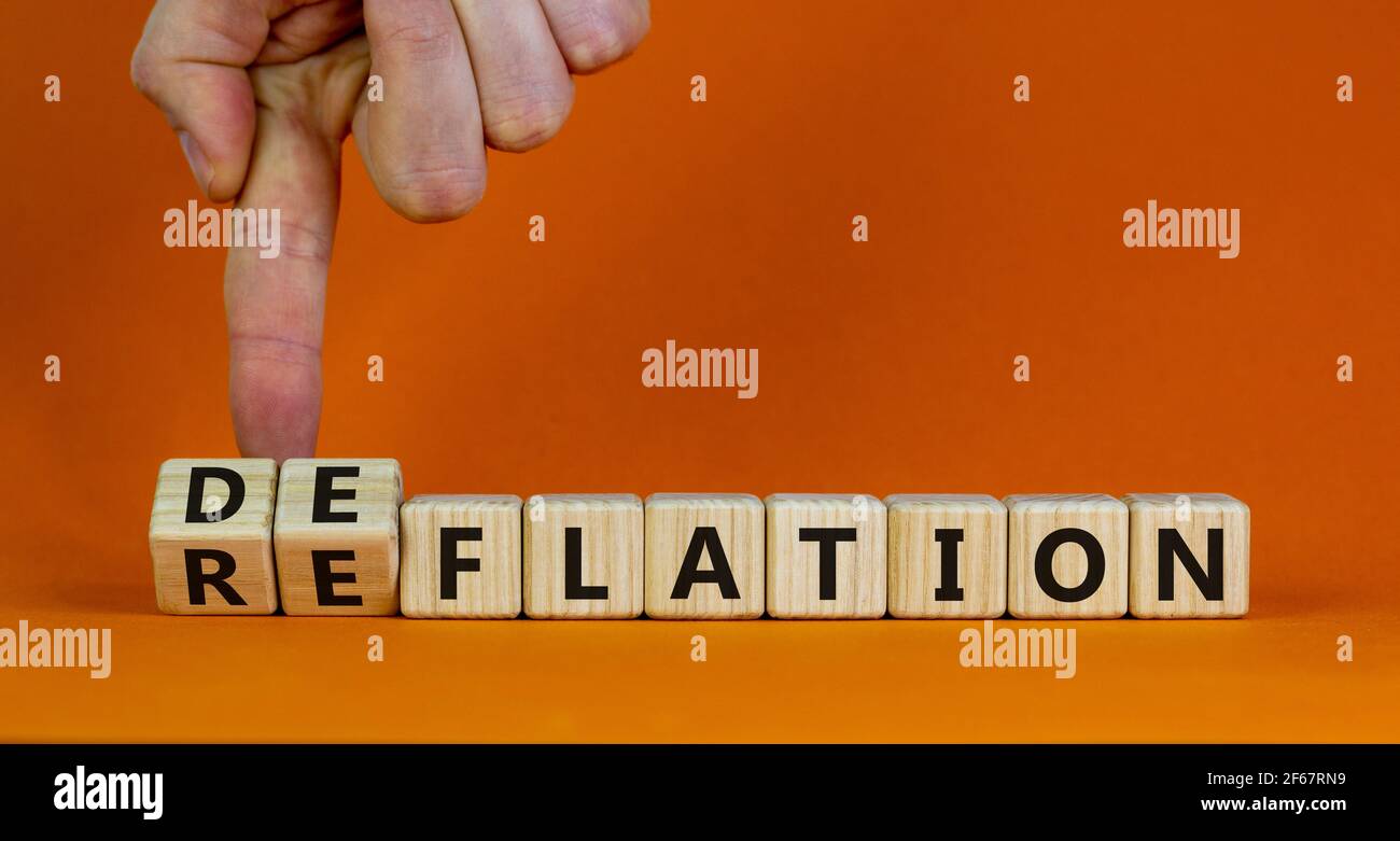 Deflation or reflation symbol. Businessman turns cubes and changes the ...