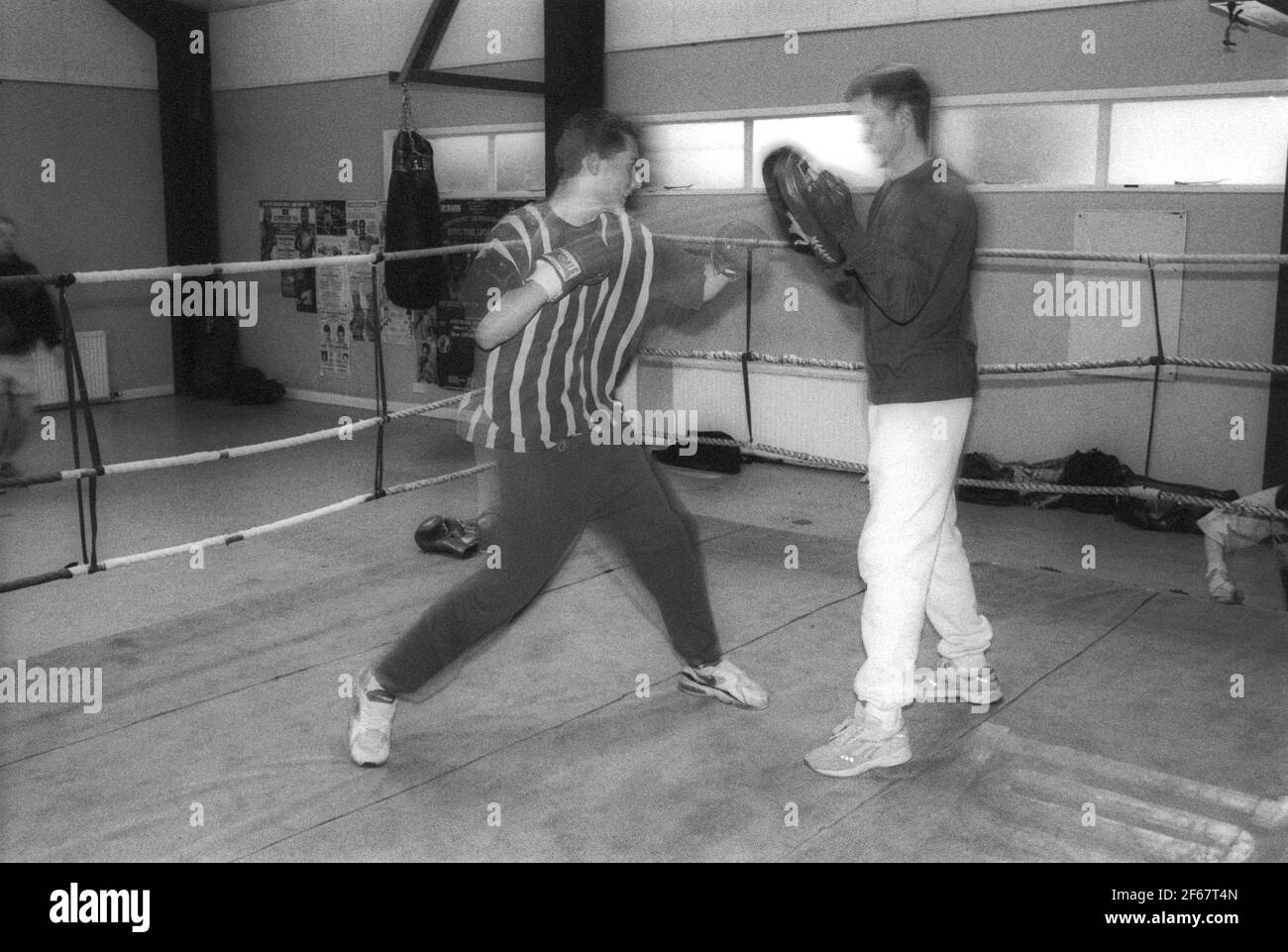 Young boxer working with his trainer at boxing club Stock Photo - Alamy