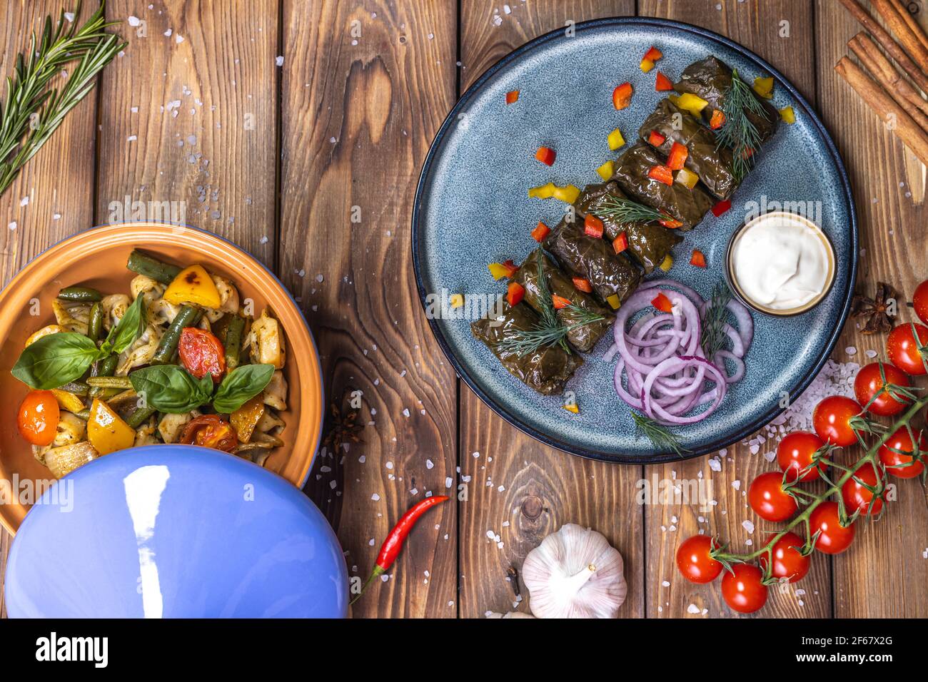 Dolma in grape leaves on a platter on a brown wooden background ...