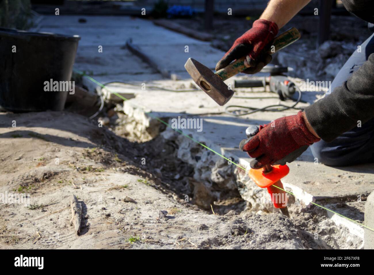Defocus construction worker. Male hands in red work gloves hold a ...