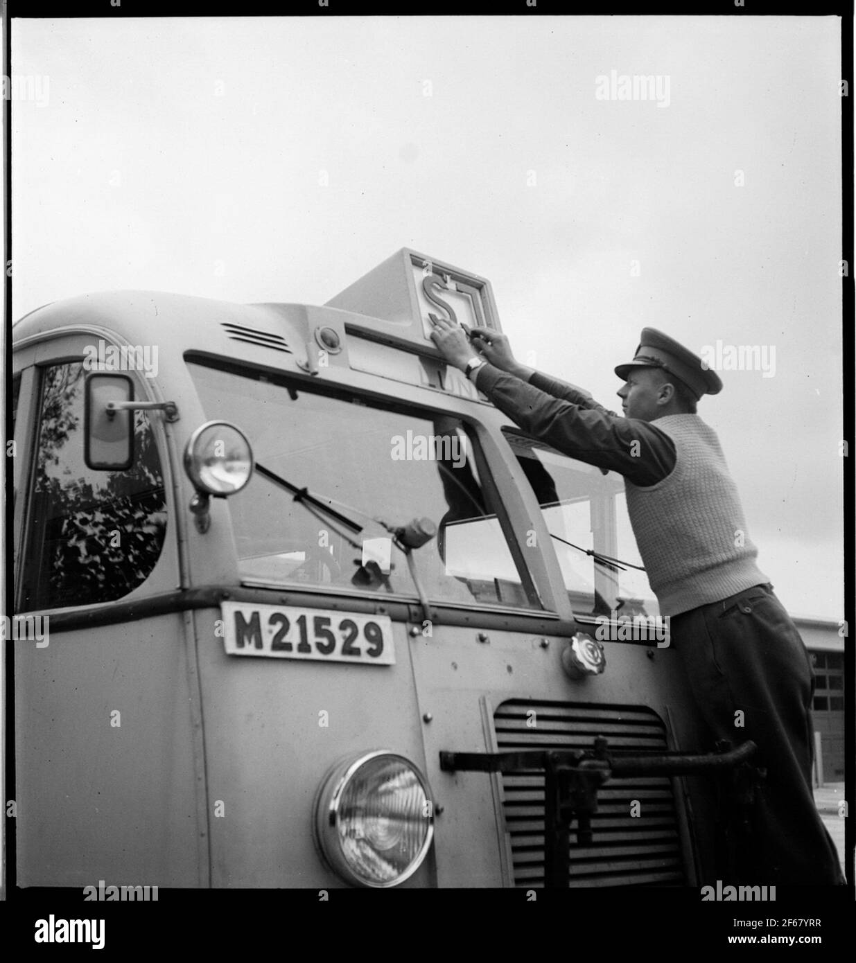 Mounting the state railways, SJ's emblem on a bus Stock Photo - Alamy