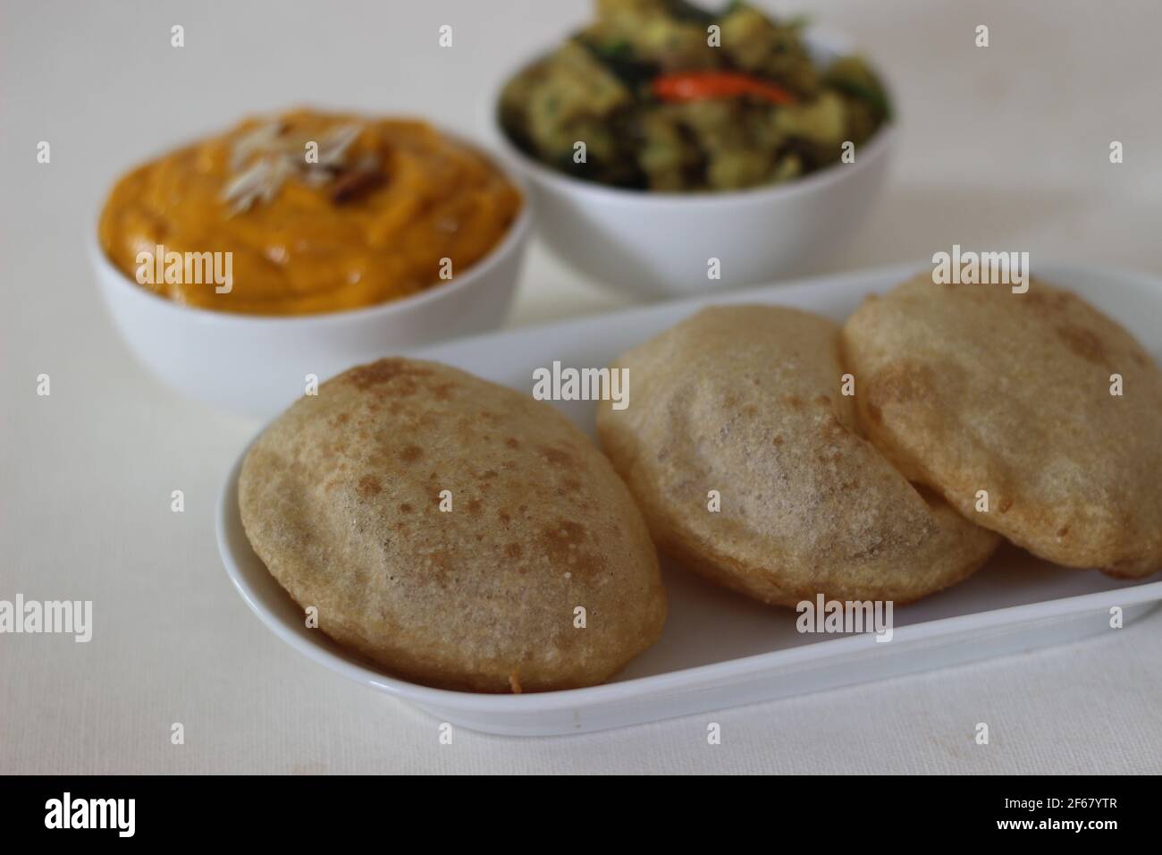 Puri served with mango pulp and potato masala. Locally known as puri ...