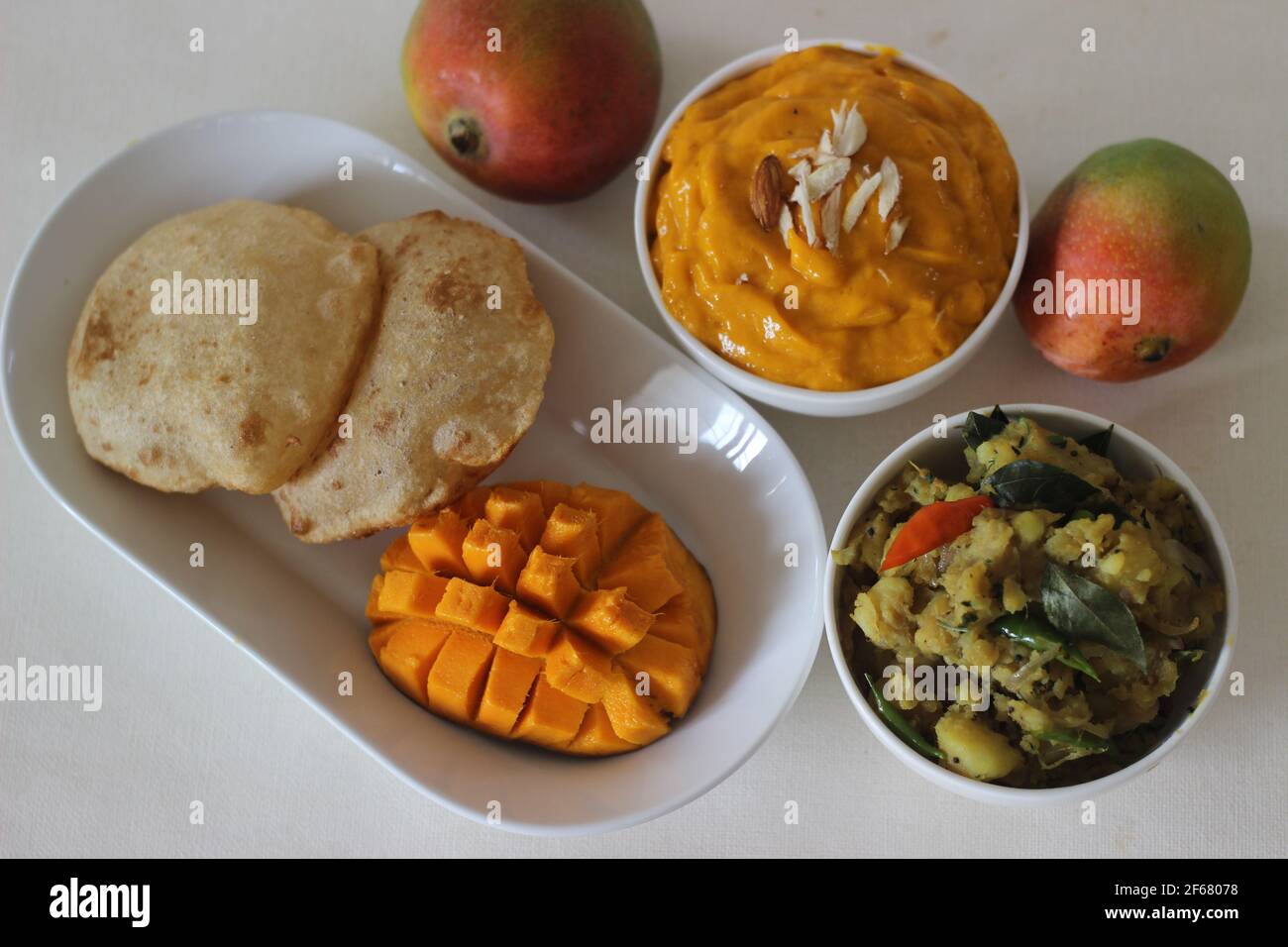 Puri served with mango pulp and potato masala. Locally known as puri ...
