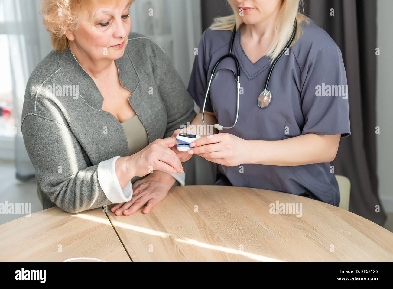 Doctor measuring patients hemoglobin level. Showing usage of finger ...