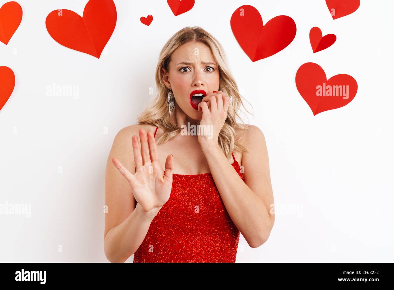 Scared beautiful girl showing stop gesture at camera isolated over ...