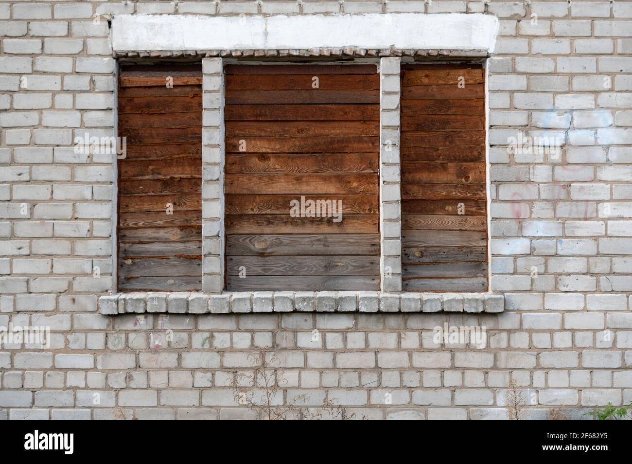 The window into the building is covered with wooden planks. Wooden ...
