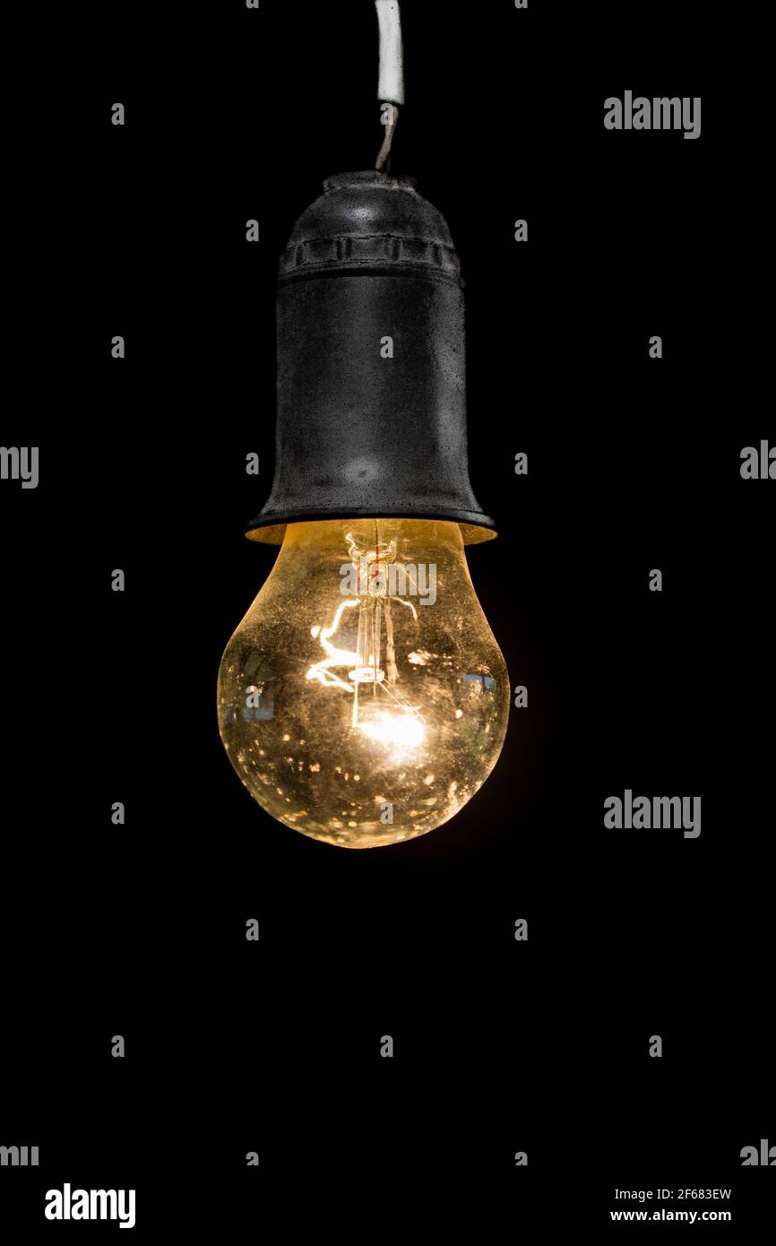 retro shining light bulb on a black background Stock Photo - Alamy