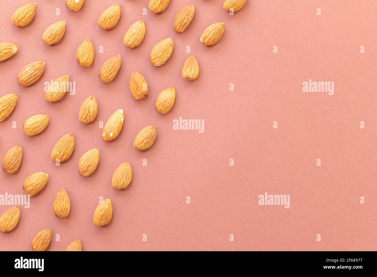 almond nuts pattern on brown background Stock Photo - Alamy