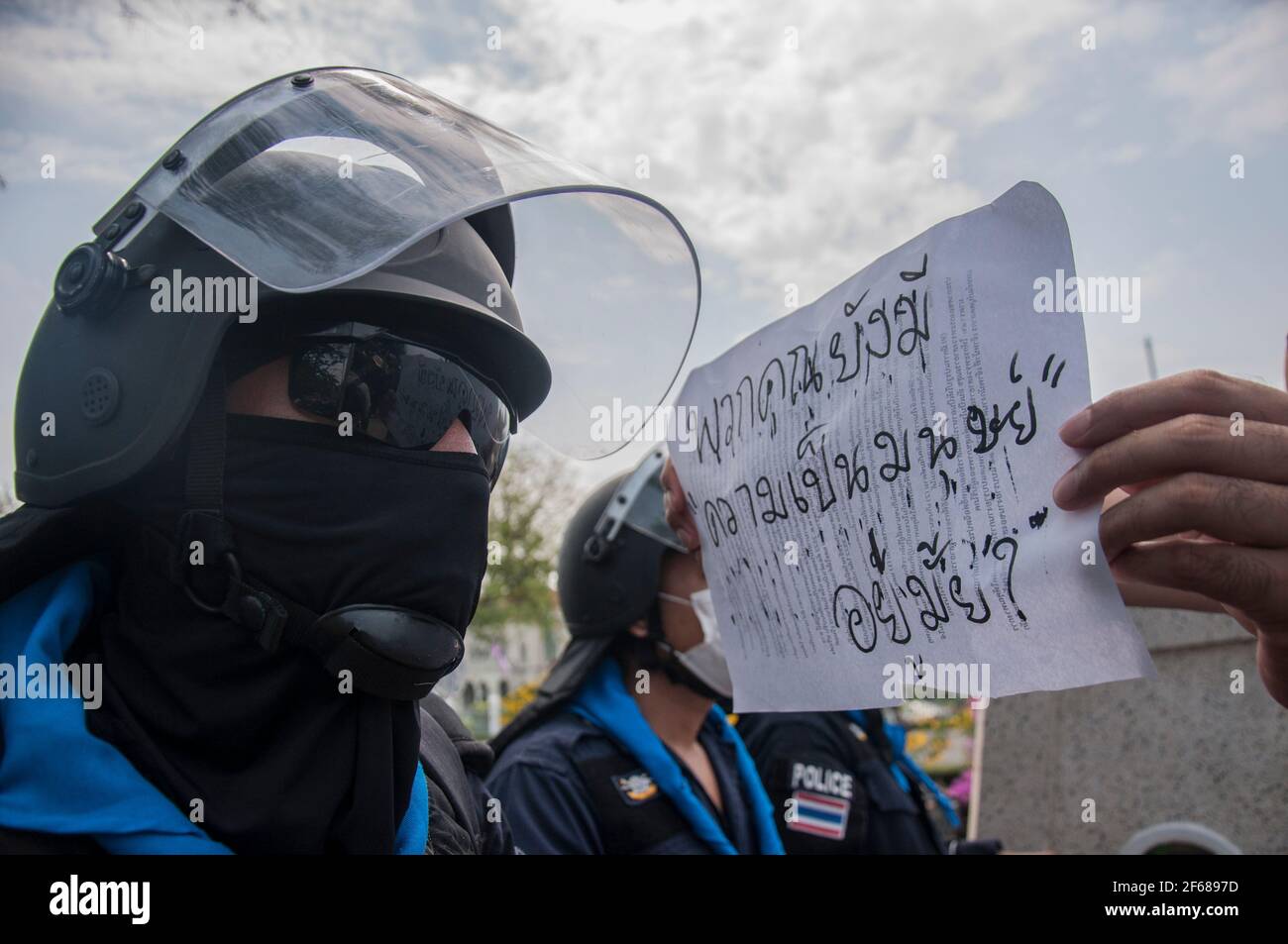 A protester holds a placard saying "Do you have the humanity ?" in ...