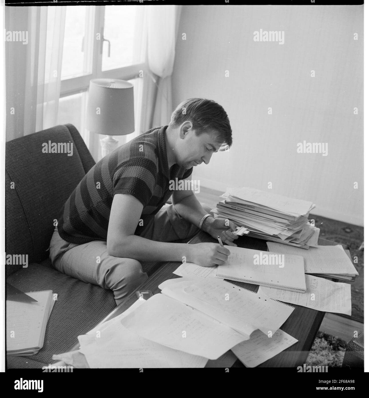 Probably Eric Lundquist's son with their study paper Stock Photo - Alamy