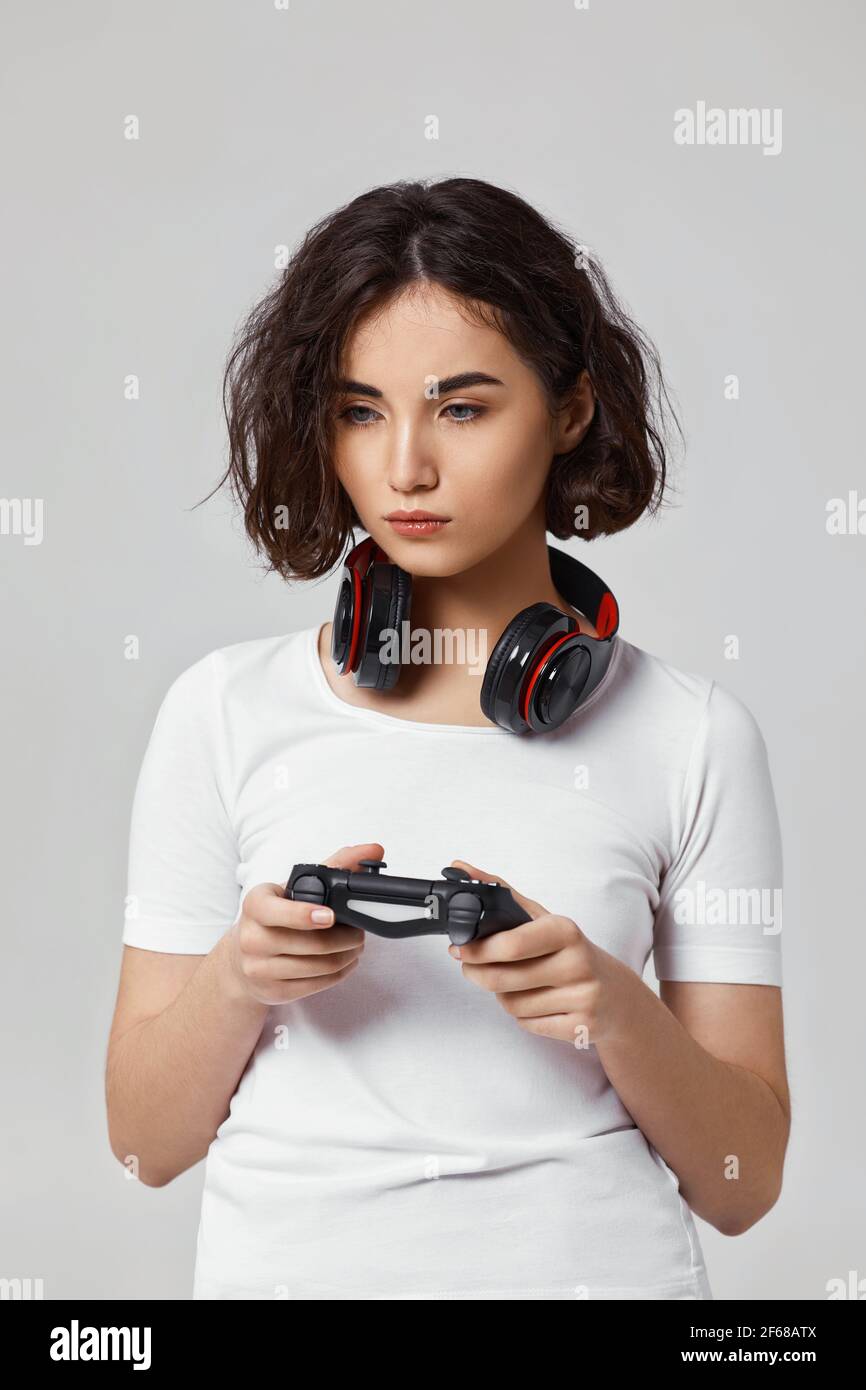 girl playing video games on gray background Stock Photo - Alamy