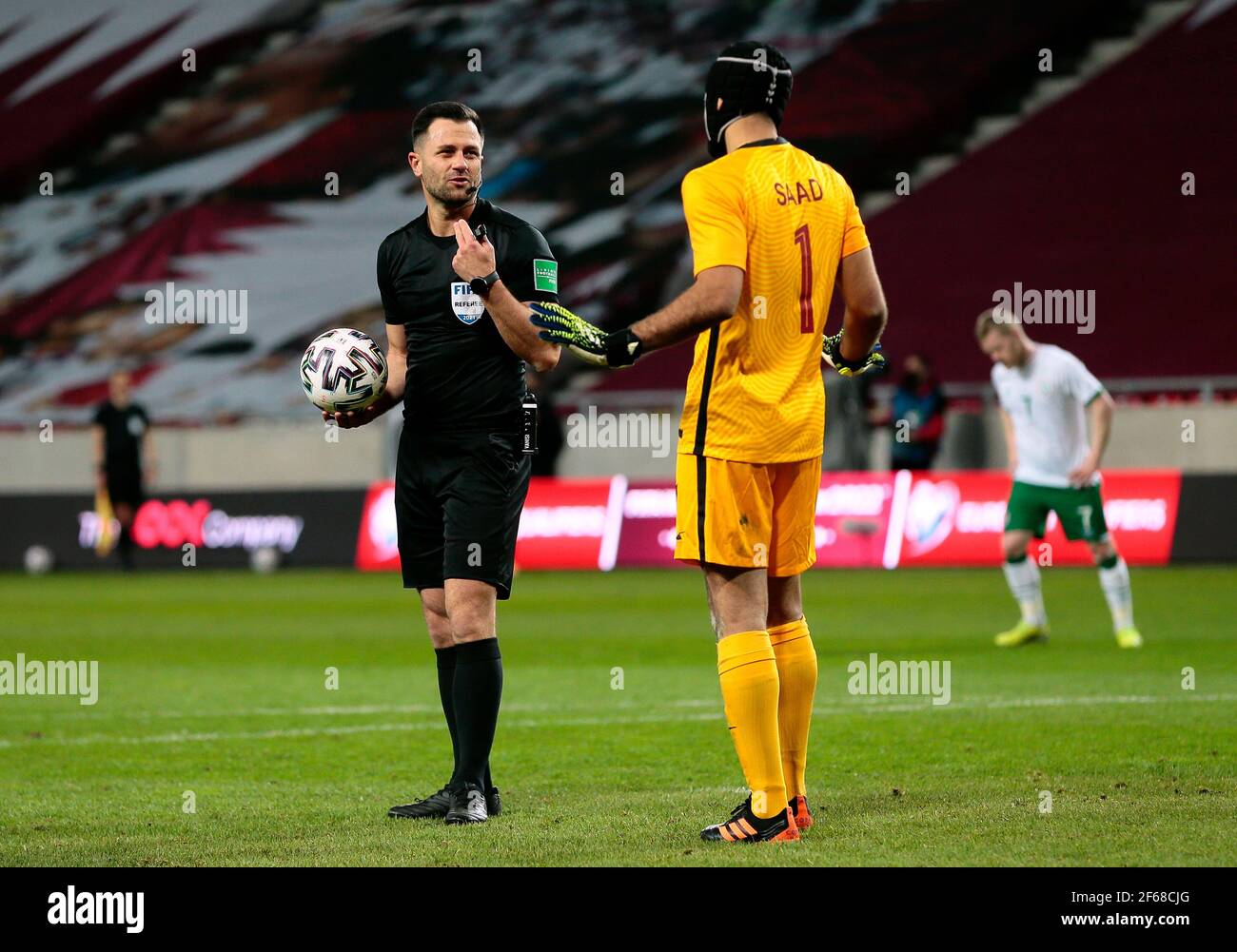 Referee Balasz Berke speaks to Qatar goalkeeper Saad Al Sheeb during ...