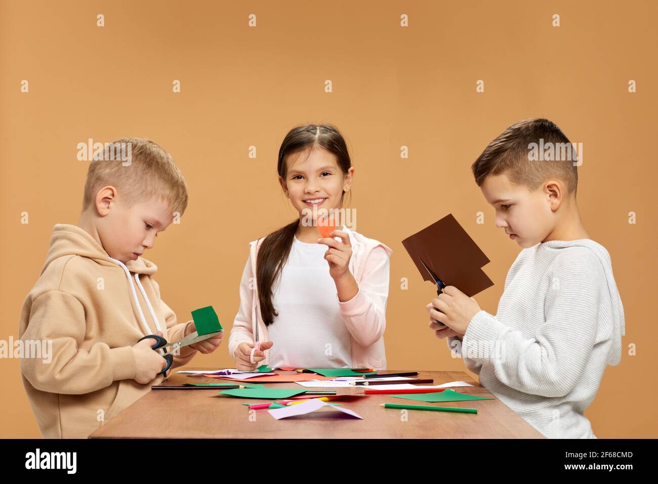 happy children cutting colored papers with scissors Stock Photo - Alamy