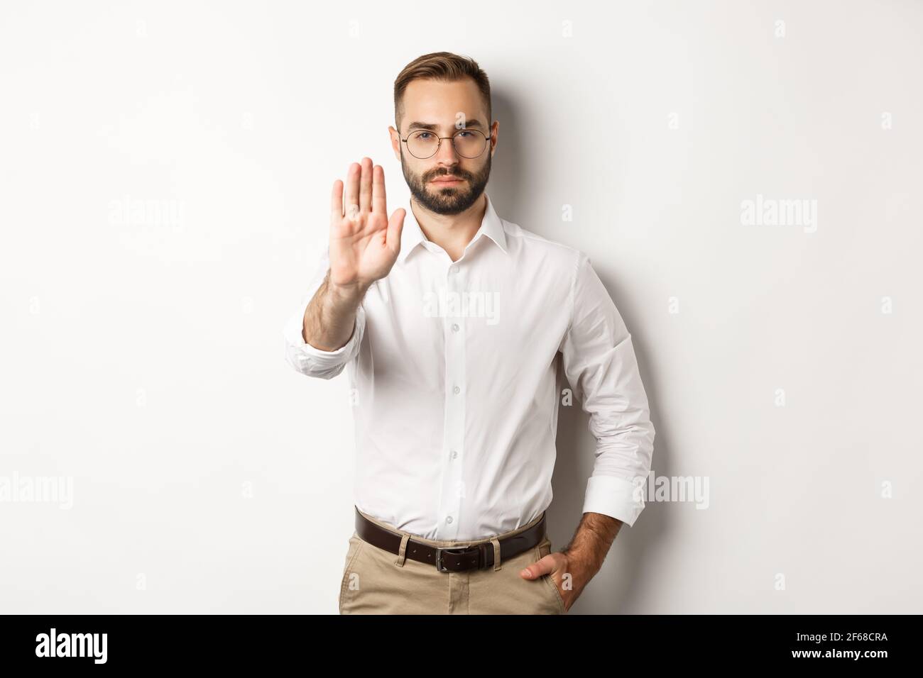 Serious boss in glasses showing stop sign, telling no, forbidding ...