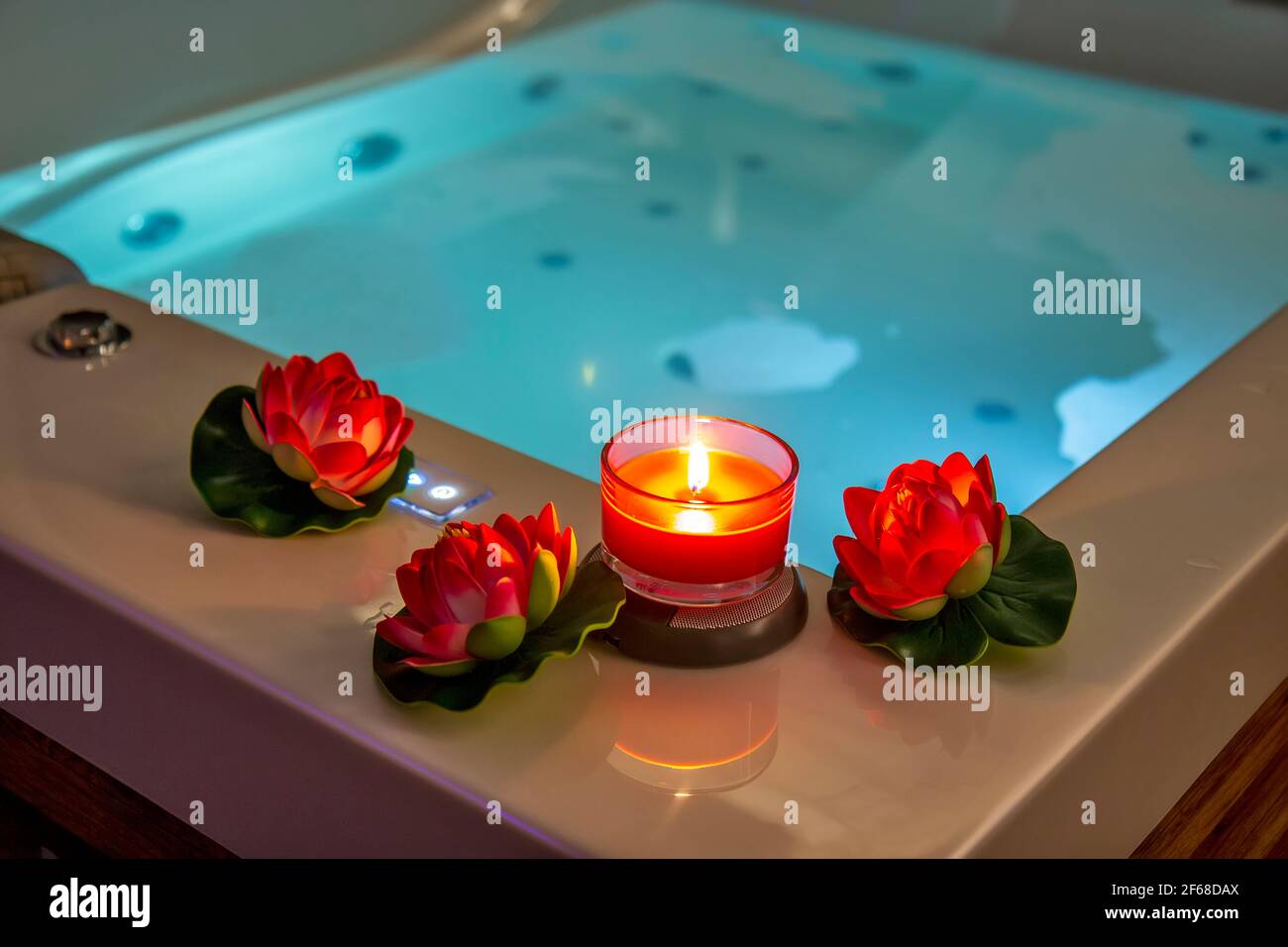 Hot tub with candles and water lilies Stock Photo - Alamy