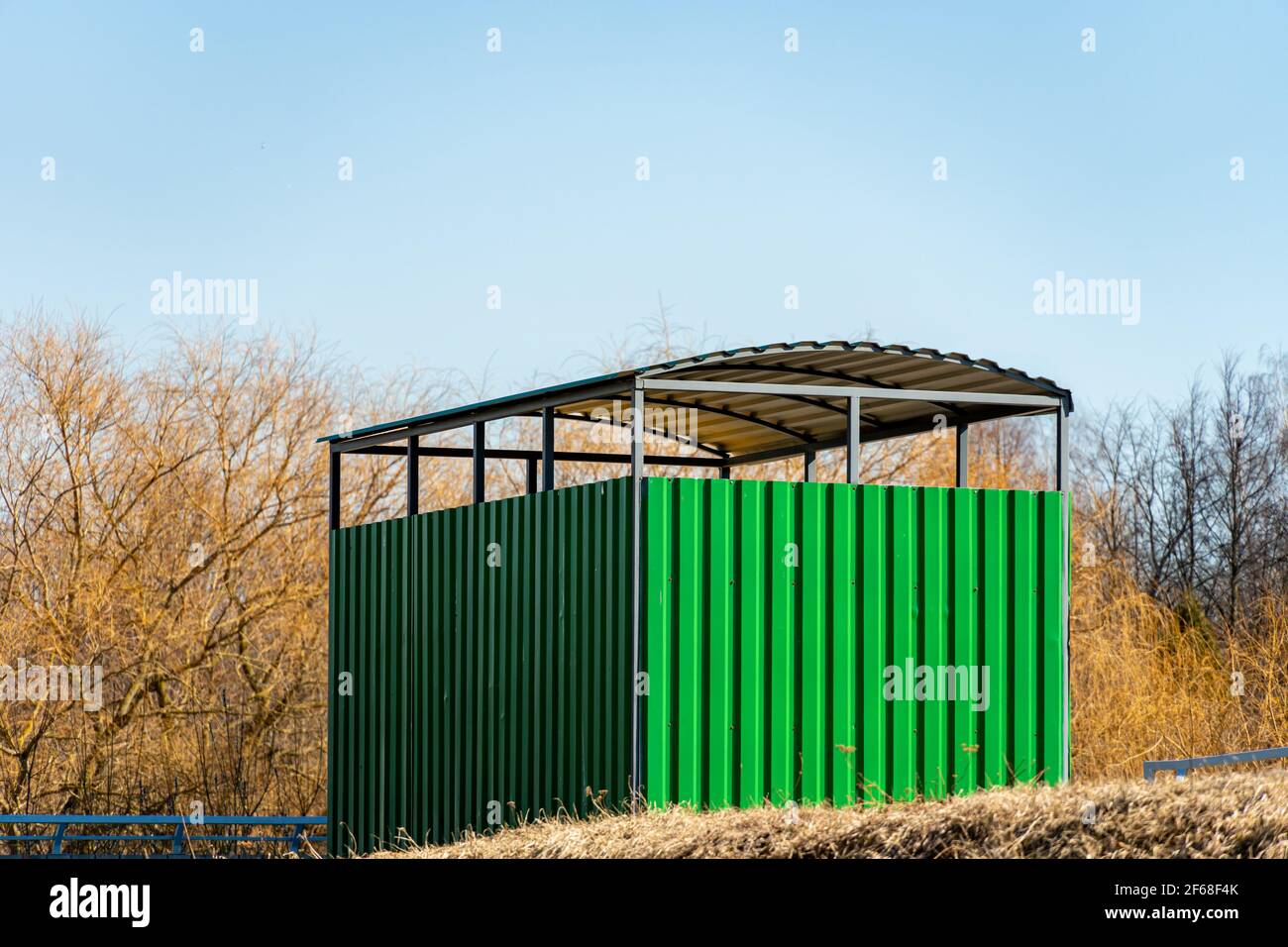 A public bus stop from a green metal profile on a spring day Stock ...