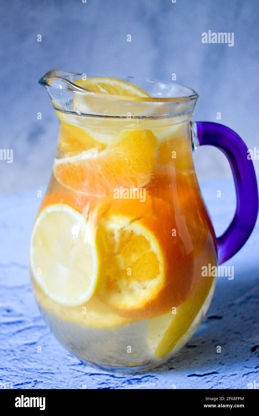 Oranges and lemons in a pitcher with water Stock Photo - Alamy