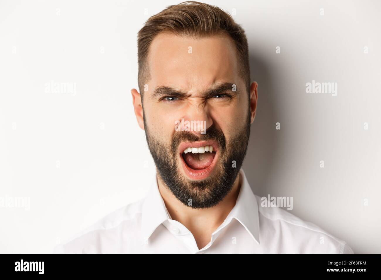 Emotions and people concept. Close-up of shocked bearded man reacting ...