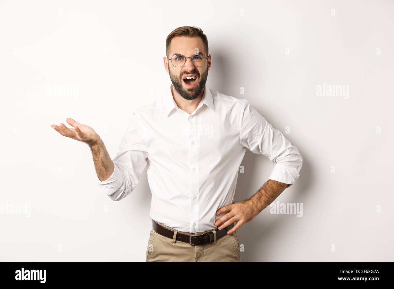 Frustrated office worker complaining, gesturing and looking ...