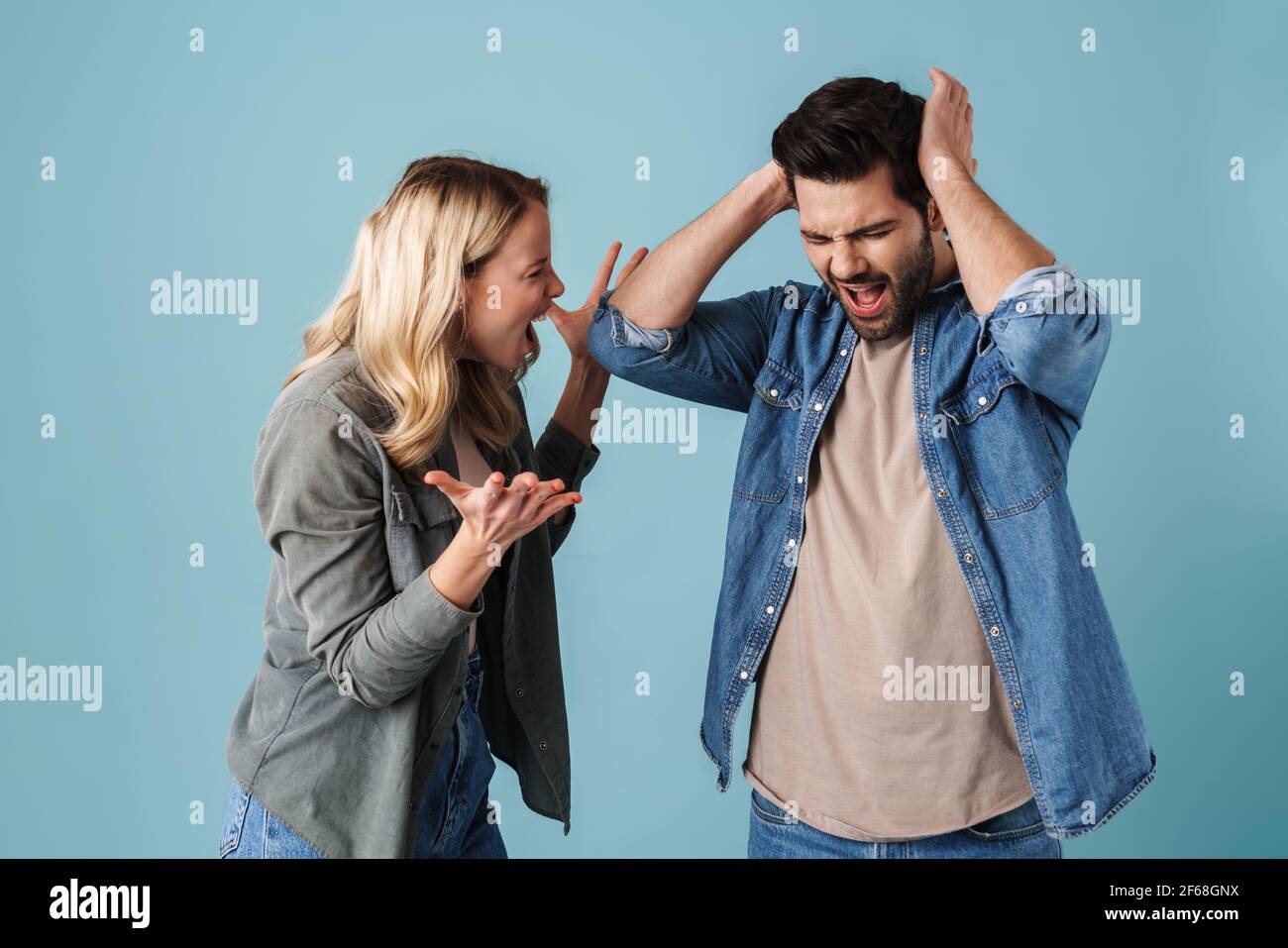 Young irritated man and woman screaming while having argument isolated ...