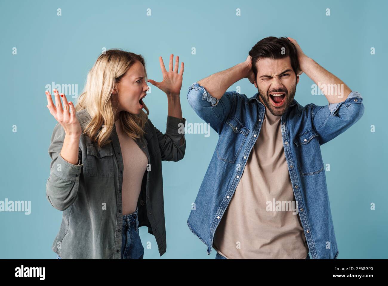 Young irritated man and woman screaming while having argument isolated ...
