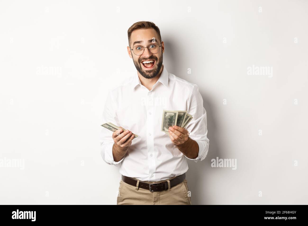 Handsome business man looking excited while counting money, standing ...