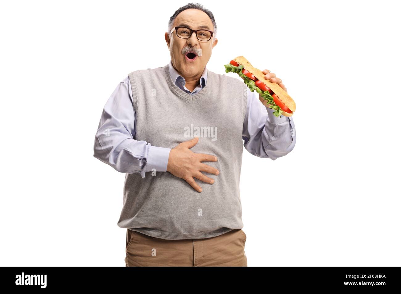 Mature man eating a sandwich and holding his belly isolated on white ...