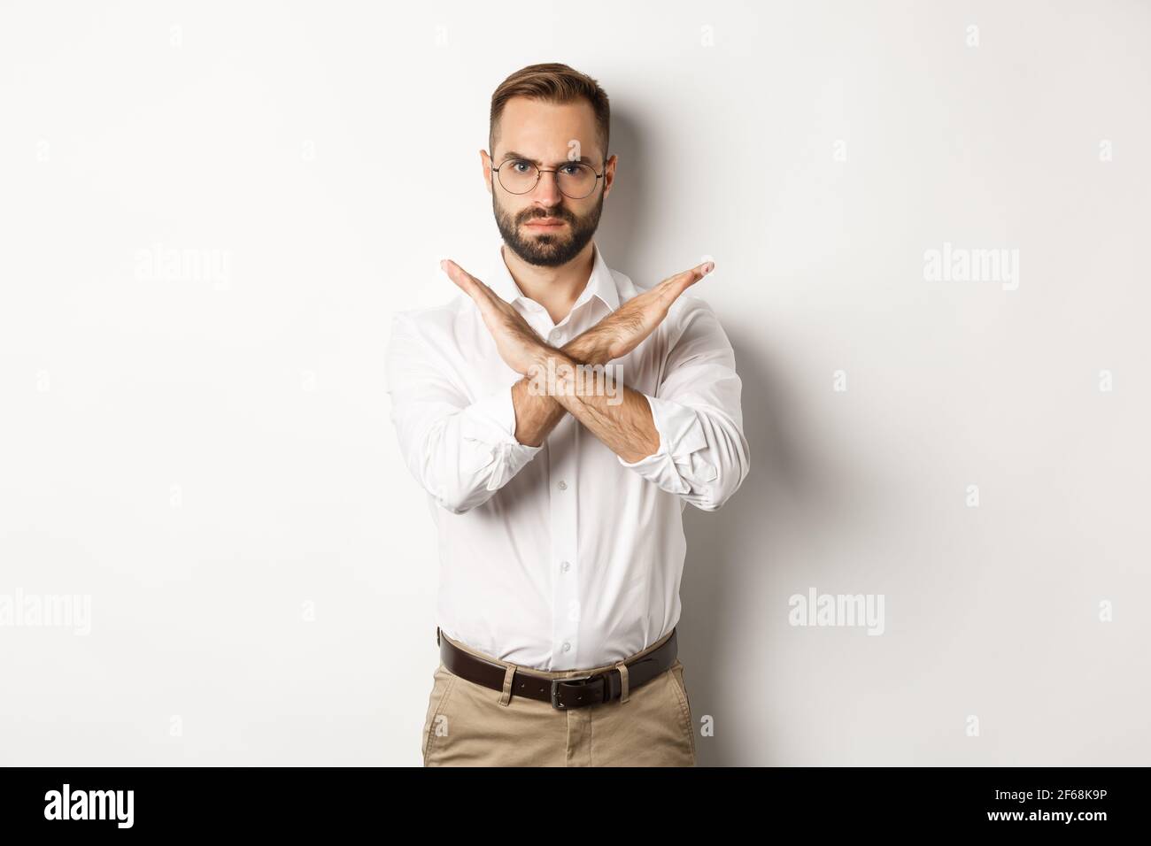 Angry businessman frowning and showing cross, stop you, telling no and ...