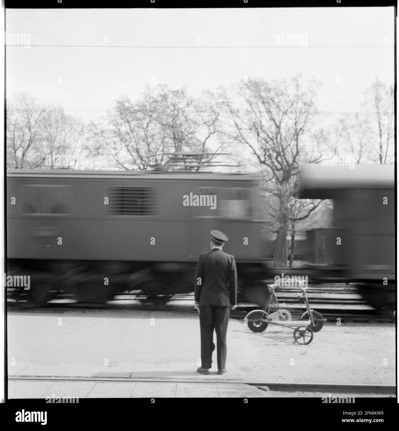 Station inspector with signal rod at passing trains Stock Photo - Alamy