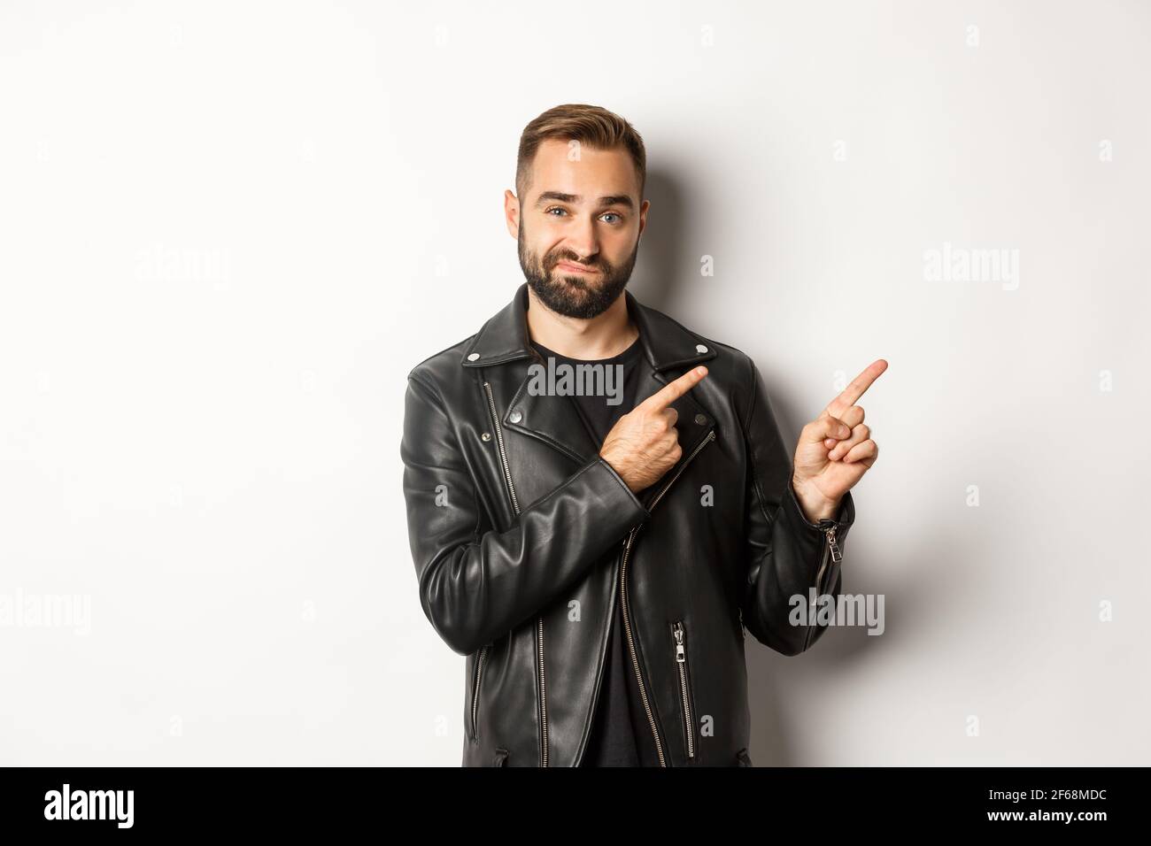 Skeptical and doubtful guy in black leather jacket, shrugging while ...