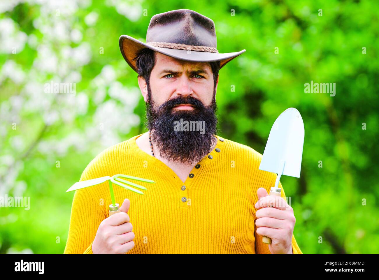 Spring farming. Gardener work. Bearded man with gardening tools. Male ...