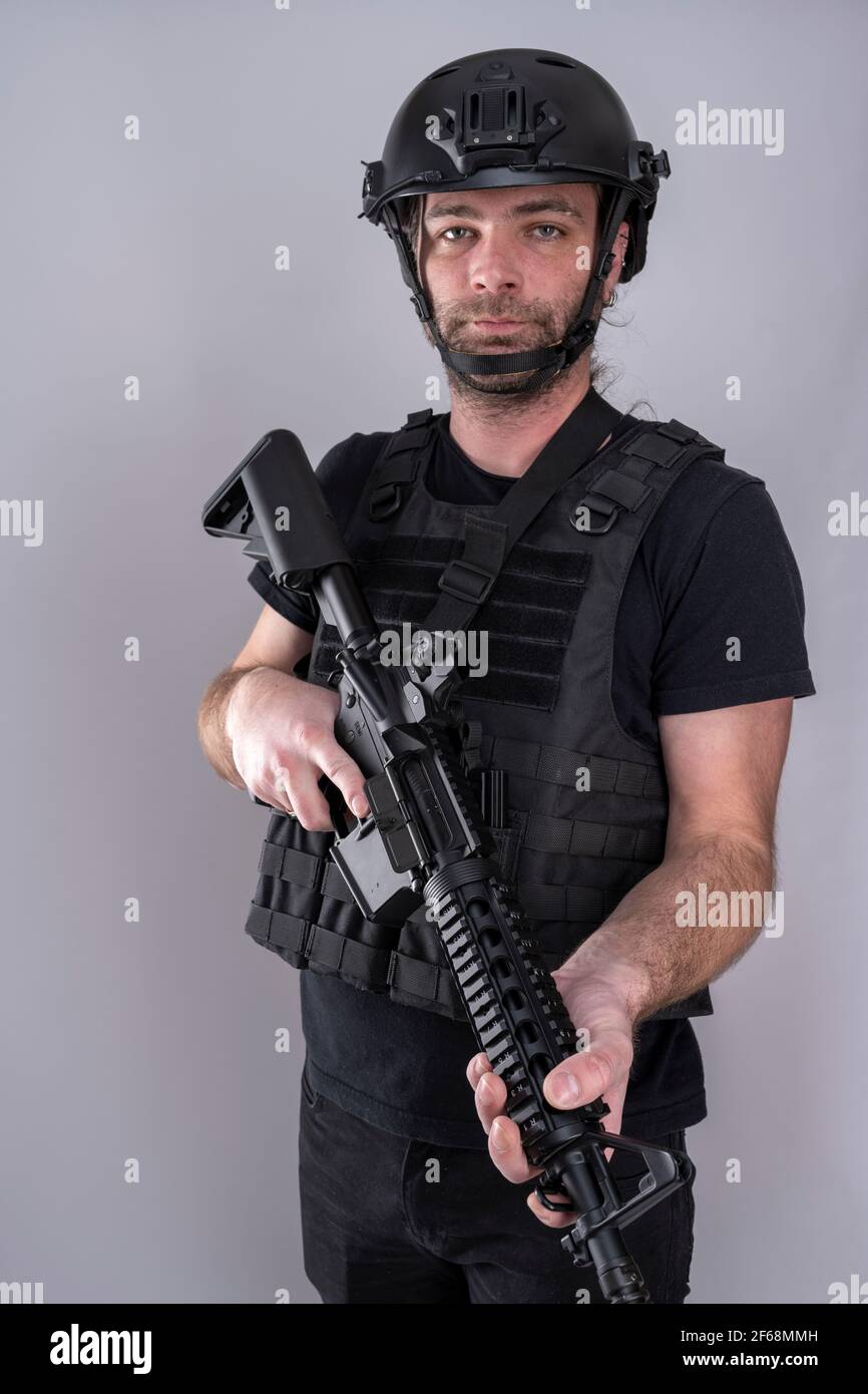 Portrait of single military male wearing his action combat clothes and ...