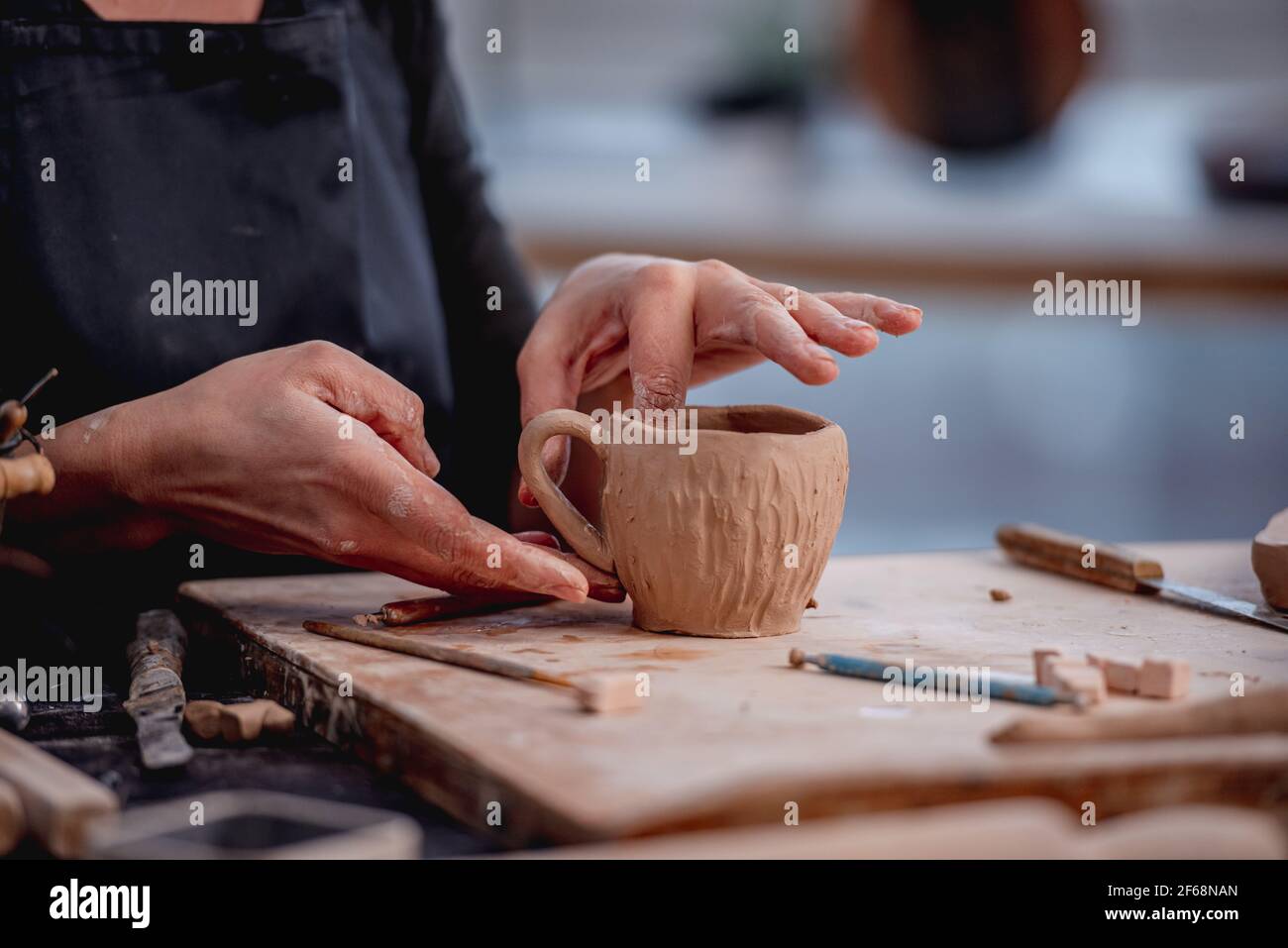 Hands of potter forming cup from clay Stock Photo - Alamy