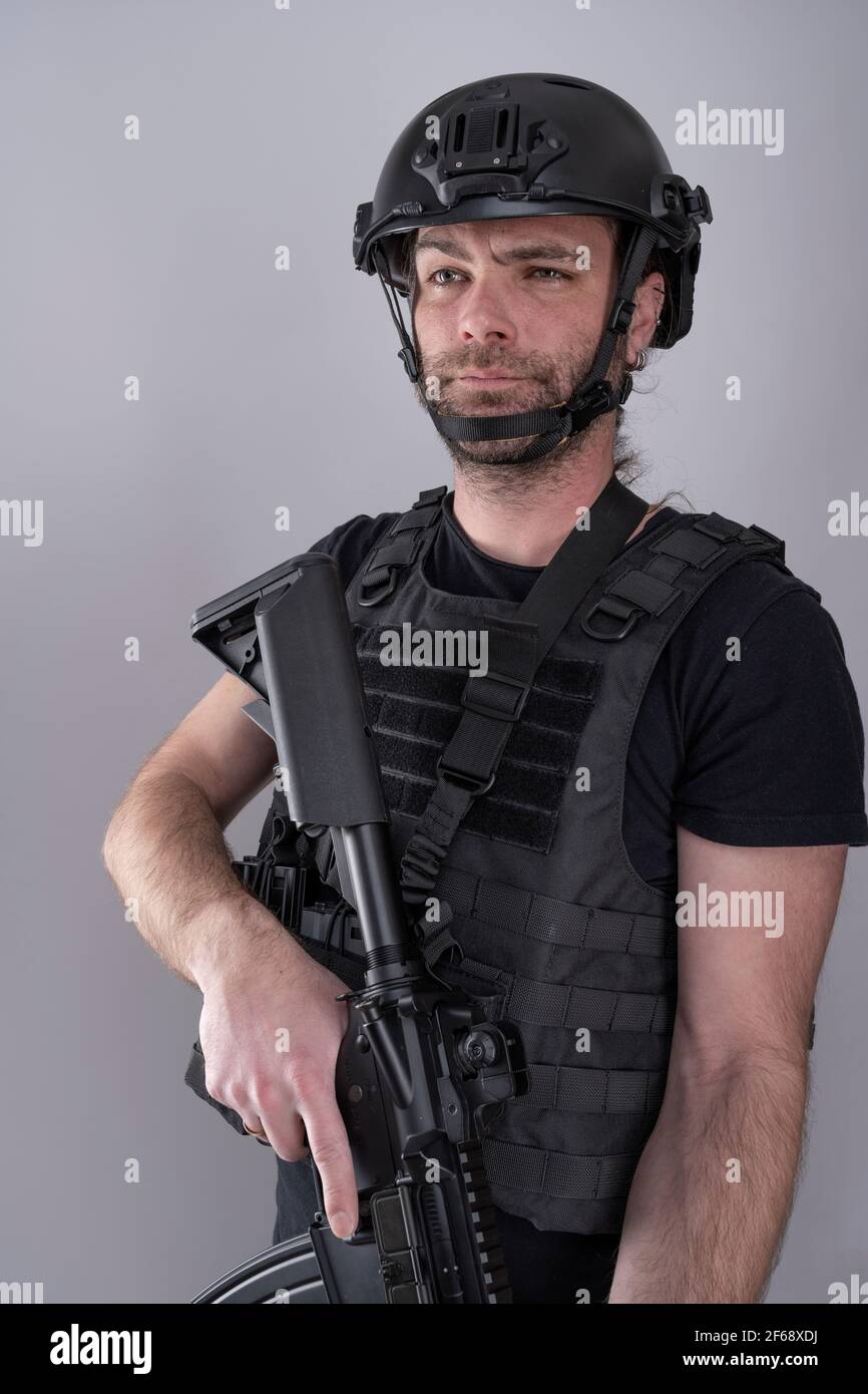 Man fully equipped for airsoft displaying a questioning face while ...