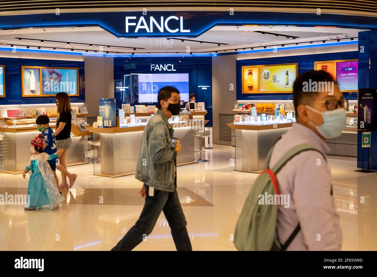 Shoppers walk past the Japanese cosmetics and dietary supplements ...