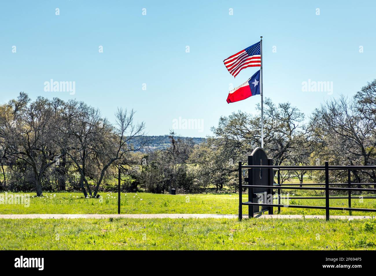 USA flag and the Texas flag waving together in the hill country Stock ...