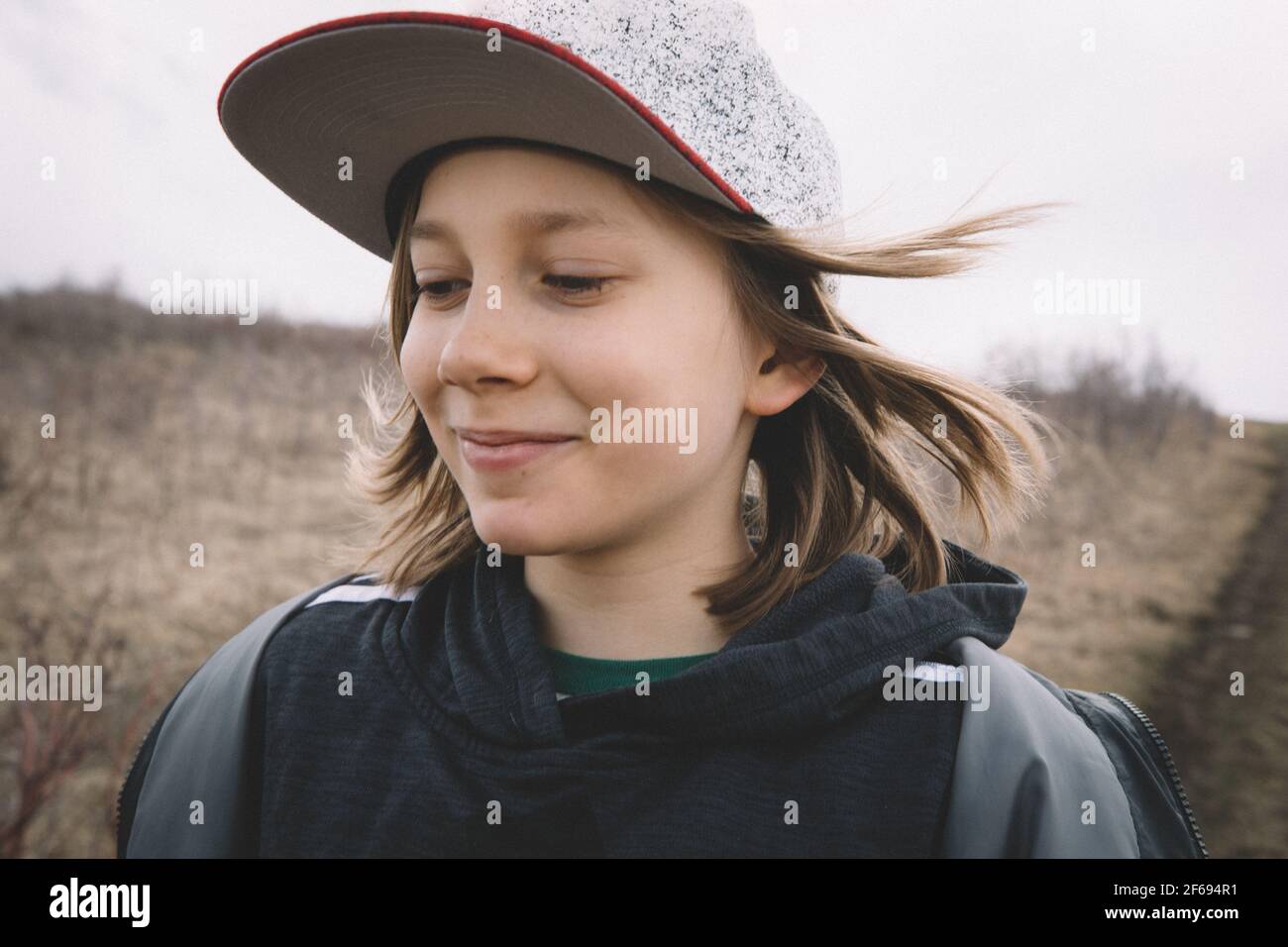 Close up shot of long haired boy on a walk with sly smirk Stock Photo ...