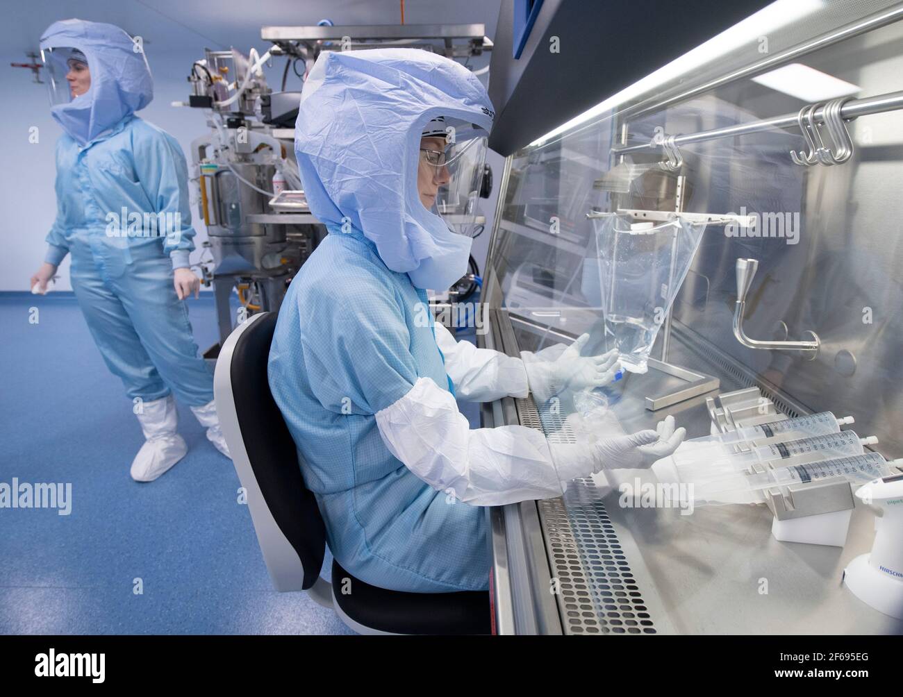 27 March 2021, Hessen, Marburg: Wearing full-body protective suits ...