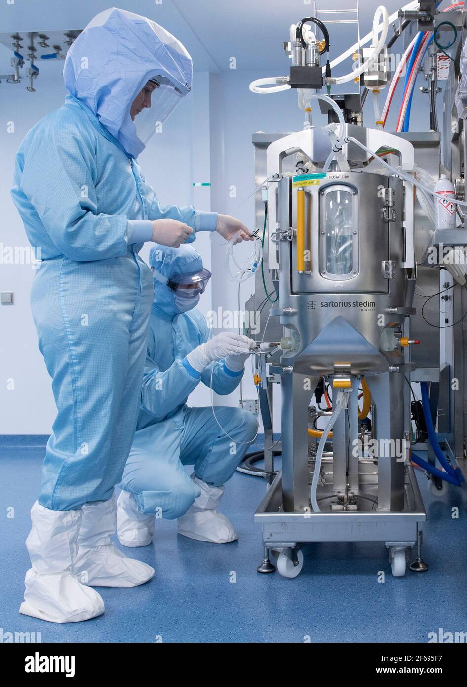 27 March 2021, Hessen, Marburg: Wearing full-body protective suits ...