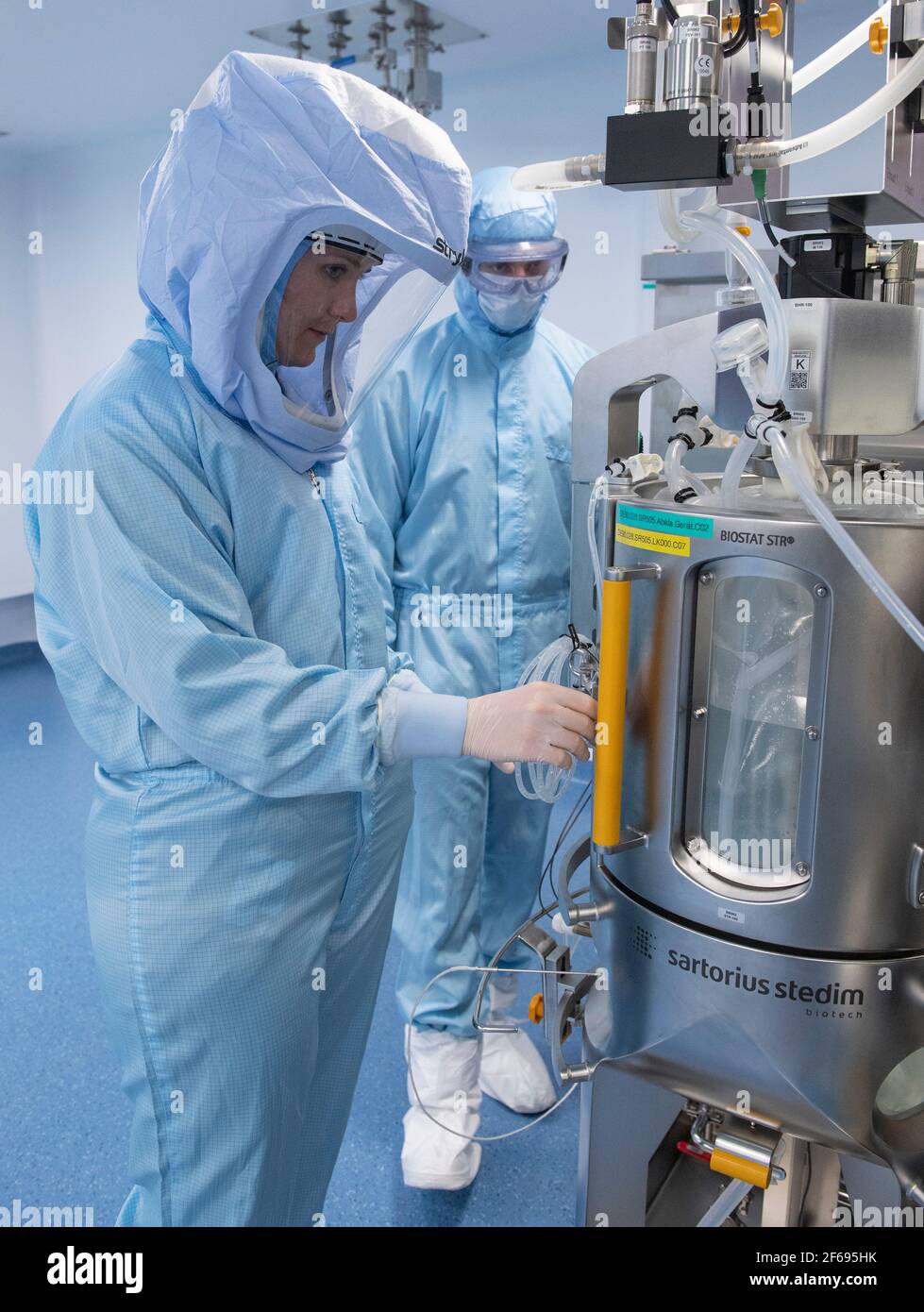 27 March 2021, Hessen, Marburg: Wearing full-body protective suits ...
