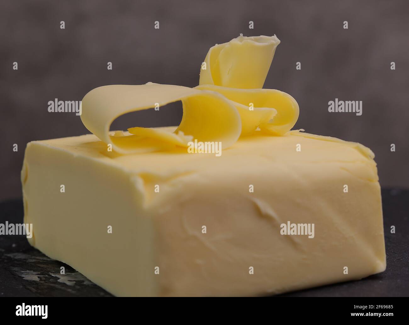 A piece of fresh butter on a plate Stock Photo - Alamy